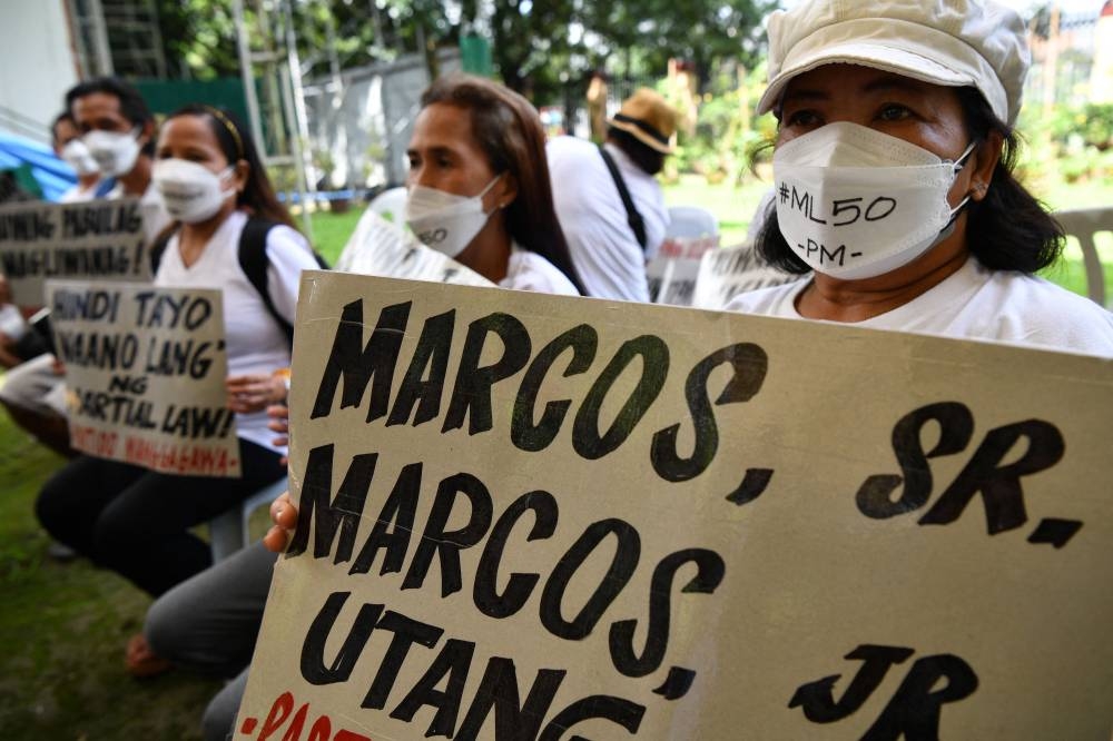 Philippine activists vow to 'never forget' Marcos era abuses | Malay Mail