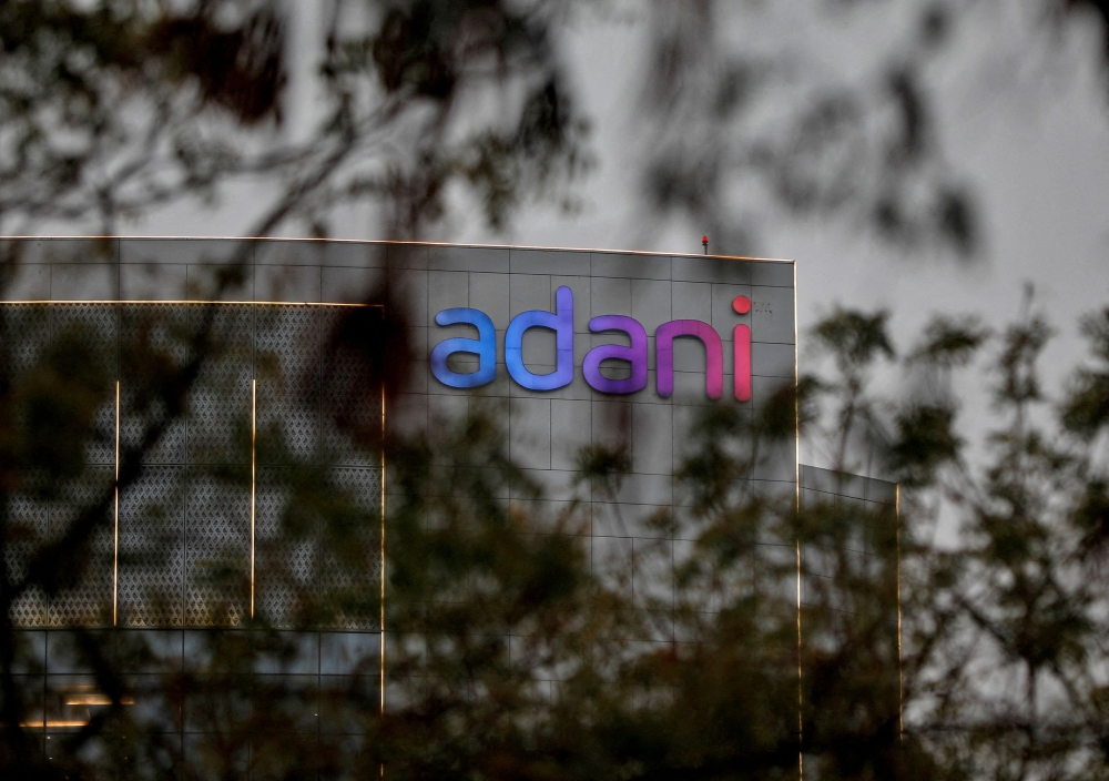 Adani group firms pledge shares for lenders of flagship company | Malay ...