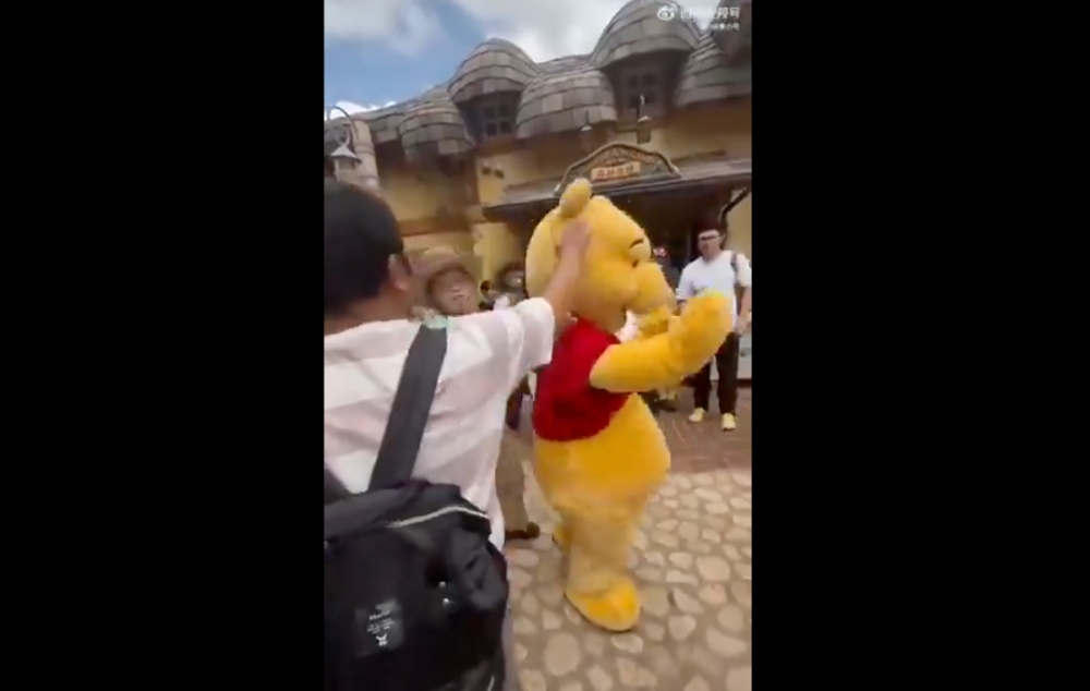 Un-bear-able: Shanghai Disneyland visitor slaps Winnie the Pooh mascot ...