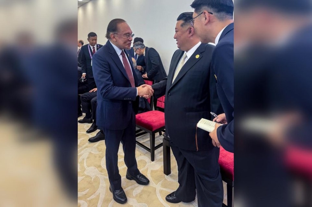 Anwar shakes hands with North Korea’s Kim Jong Un at Beijing Victory ...
